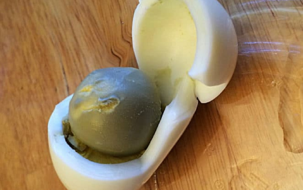 Why does a green ring form around hard-boiled egg yolks?